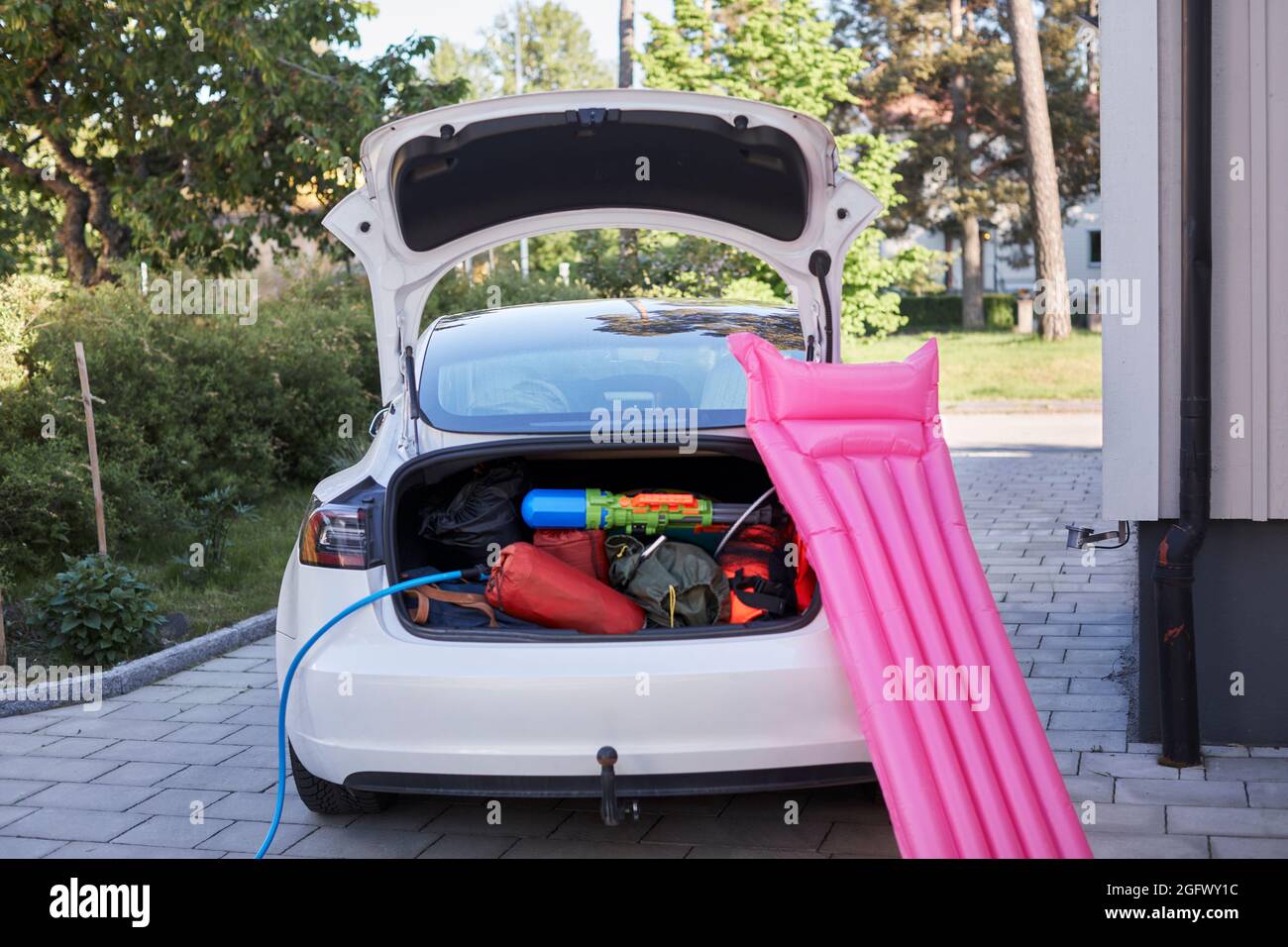 Inflatable raft leaning on electric car Stock Photo - Alamy
