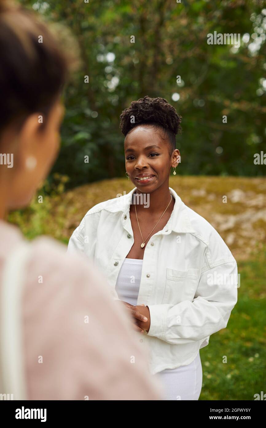 Young positive couple talking friend hi-res stock photography and ...