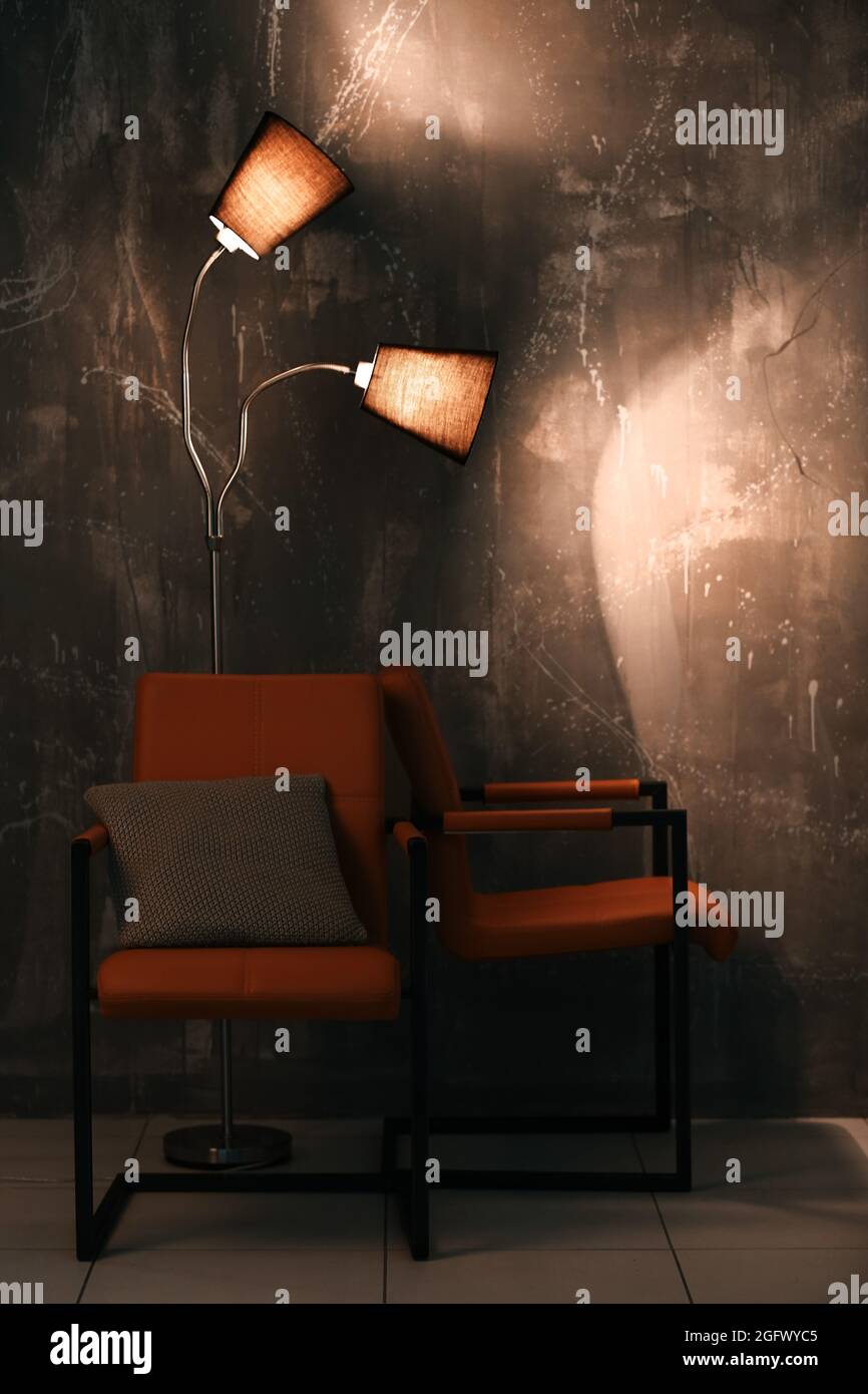Modern chairs on wall background Stock Photo - Alamy