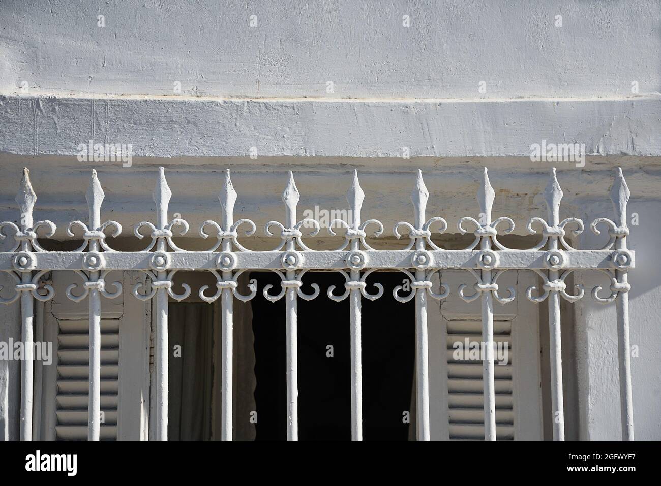 Old traditional house window with white wooden shutters and handcrafted ...