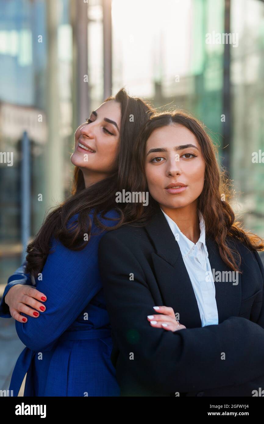 Business colleagues standing together arms hi-res stock photography and ...