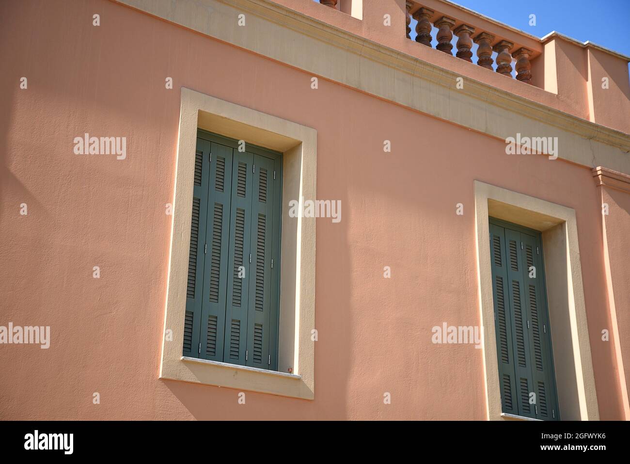 Neoclassical house facade with a Venetian stucco wall and olive green ...