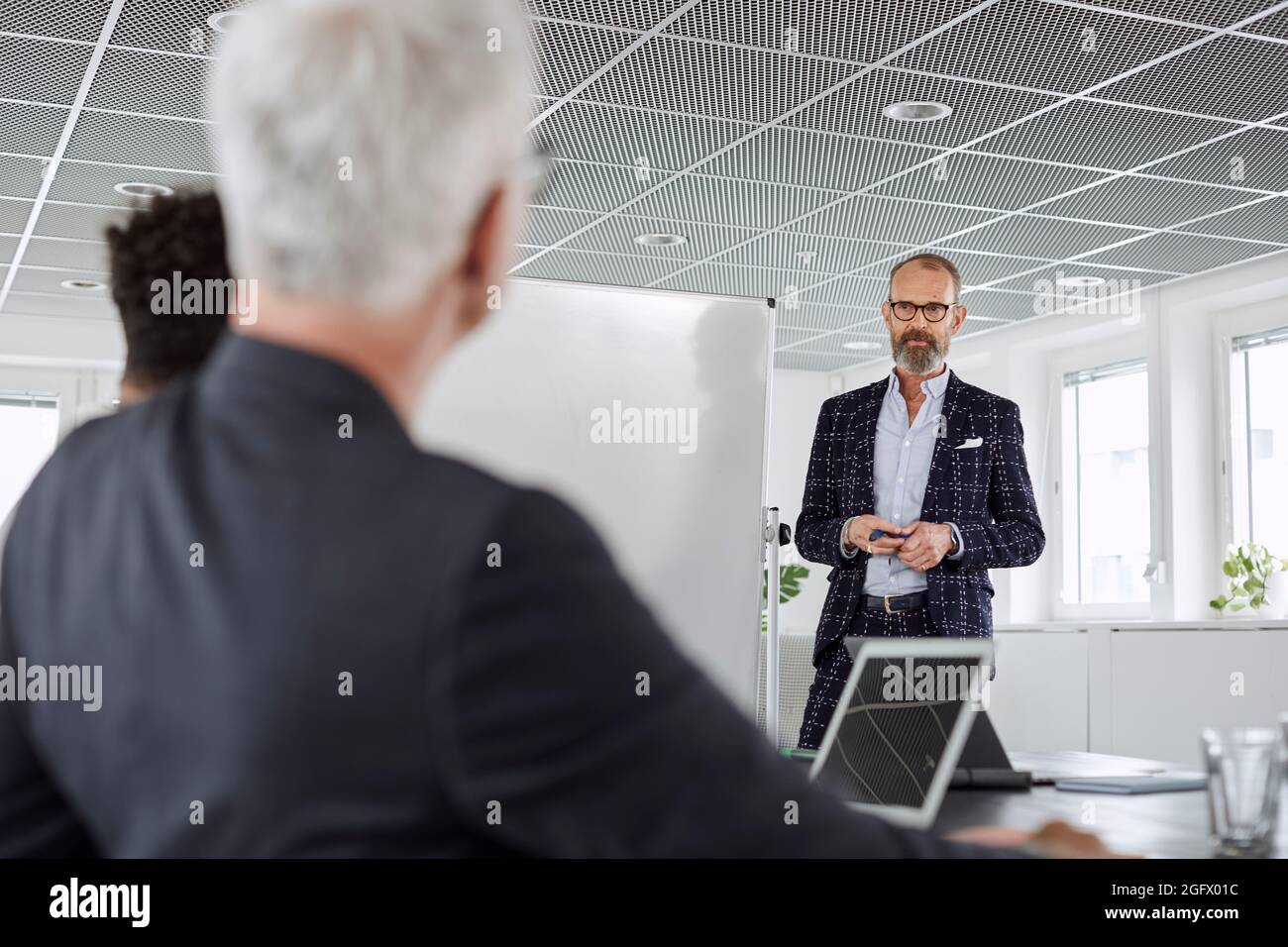 Man talking during business meeting Stock Photo - Alamy