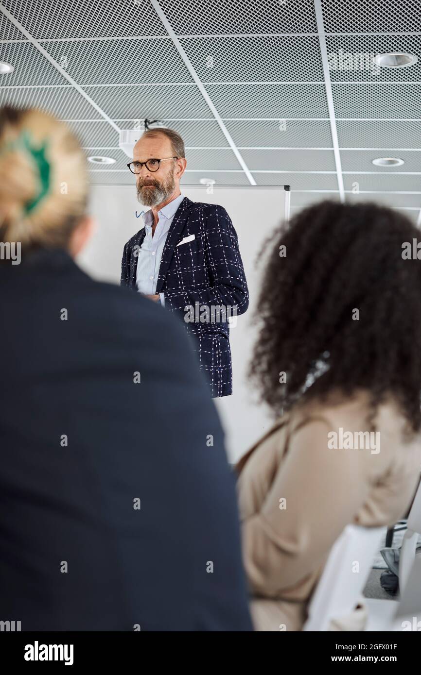 Man talking during business meeting Stock Photo - Alamy
