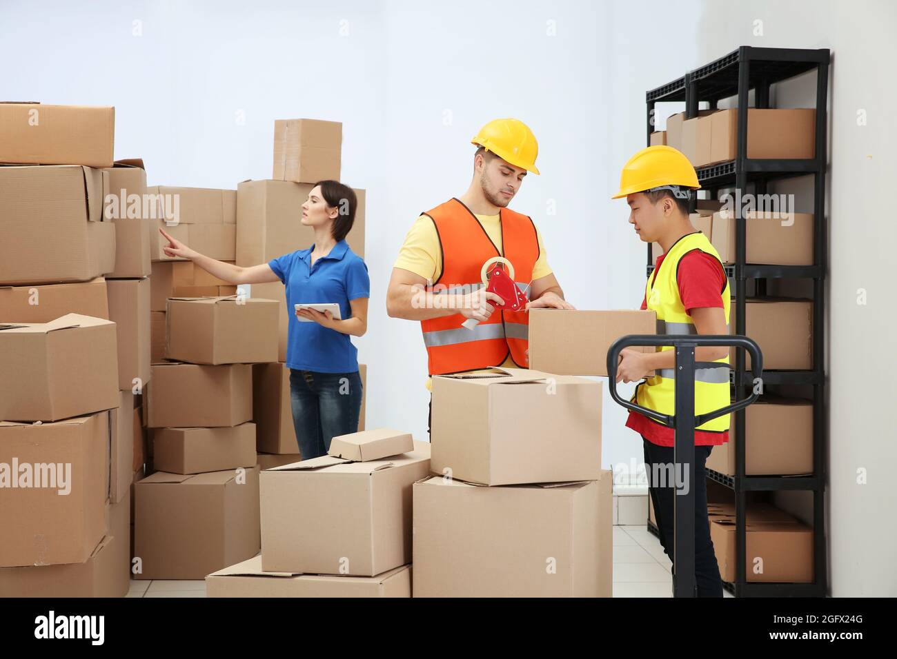 Workers packing parcels at warehouse Stock Photo - Alamy