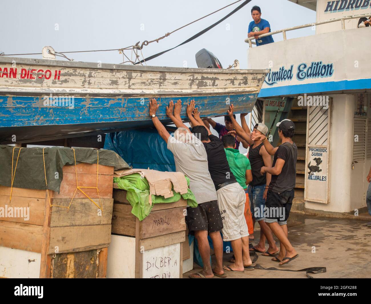 Amazon River, Peru - Sep, 2017: Porters carry the boat to the ship ...