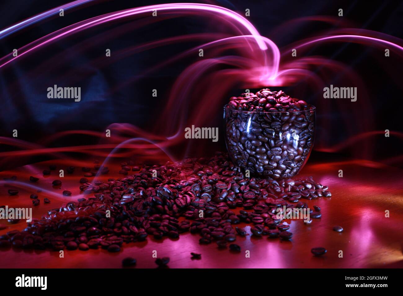 Long exposure shot of coffee beans in a transparent cup with the lights ...