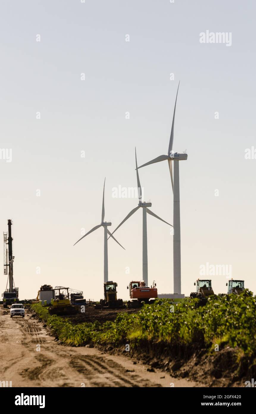 Set of three wind turbines and other heavy machinery used for the ...