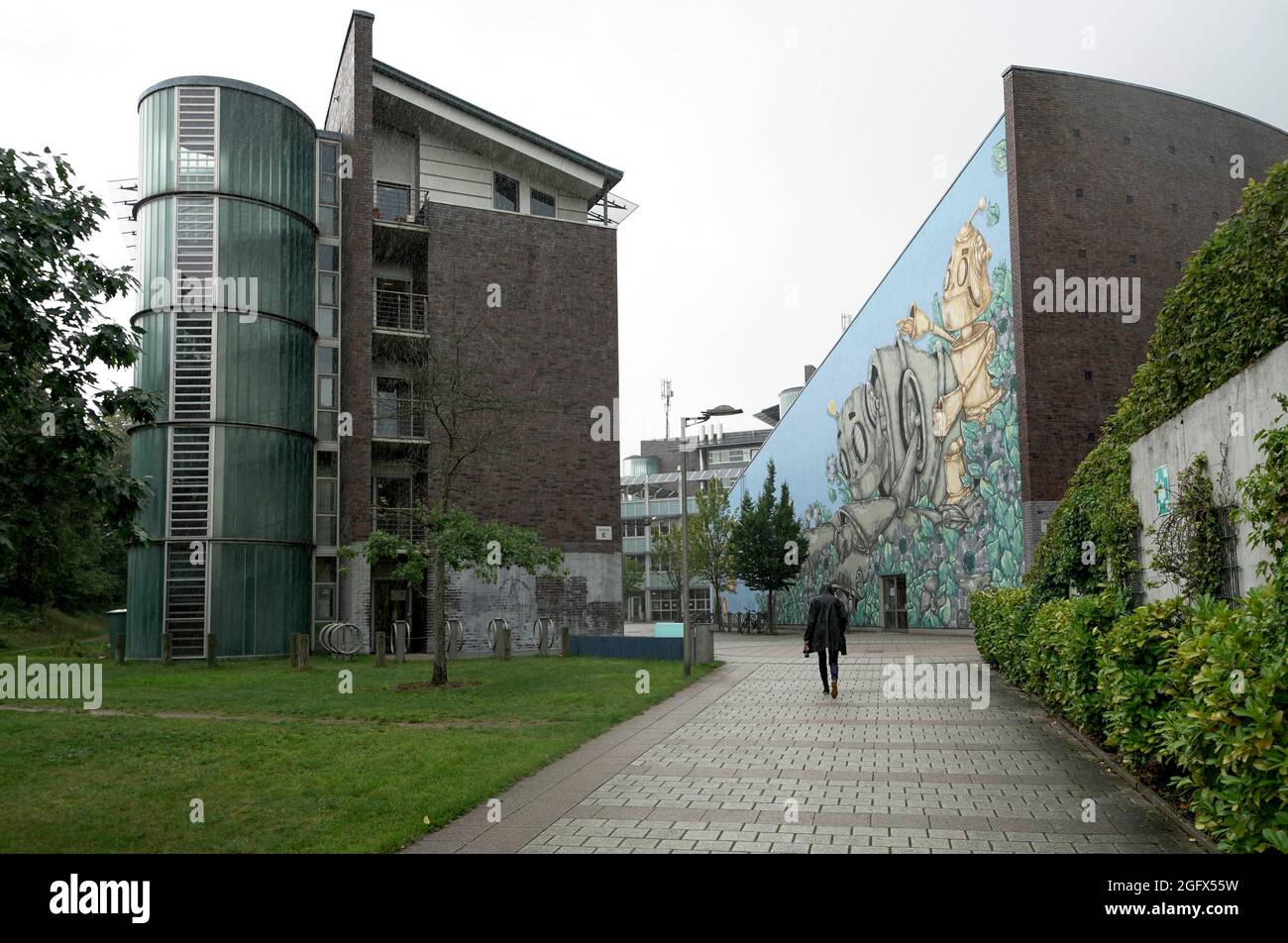 Hamburg, Germany. 27th Aug, 2021. A student walks through the rain on ...