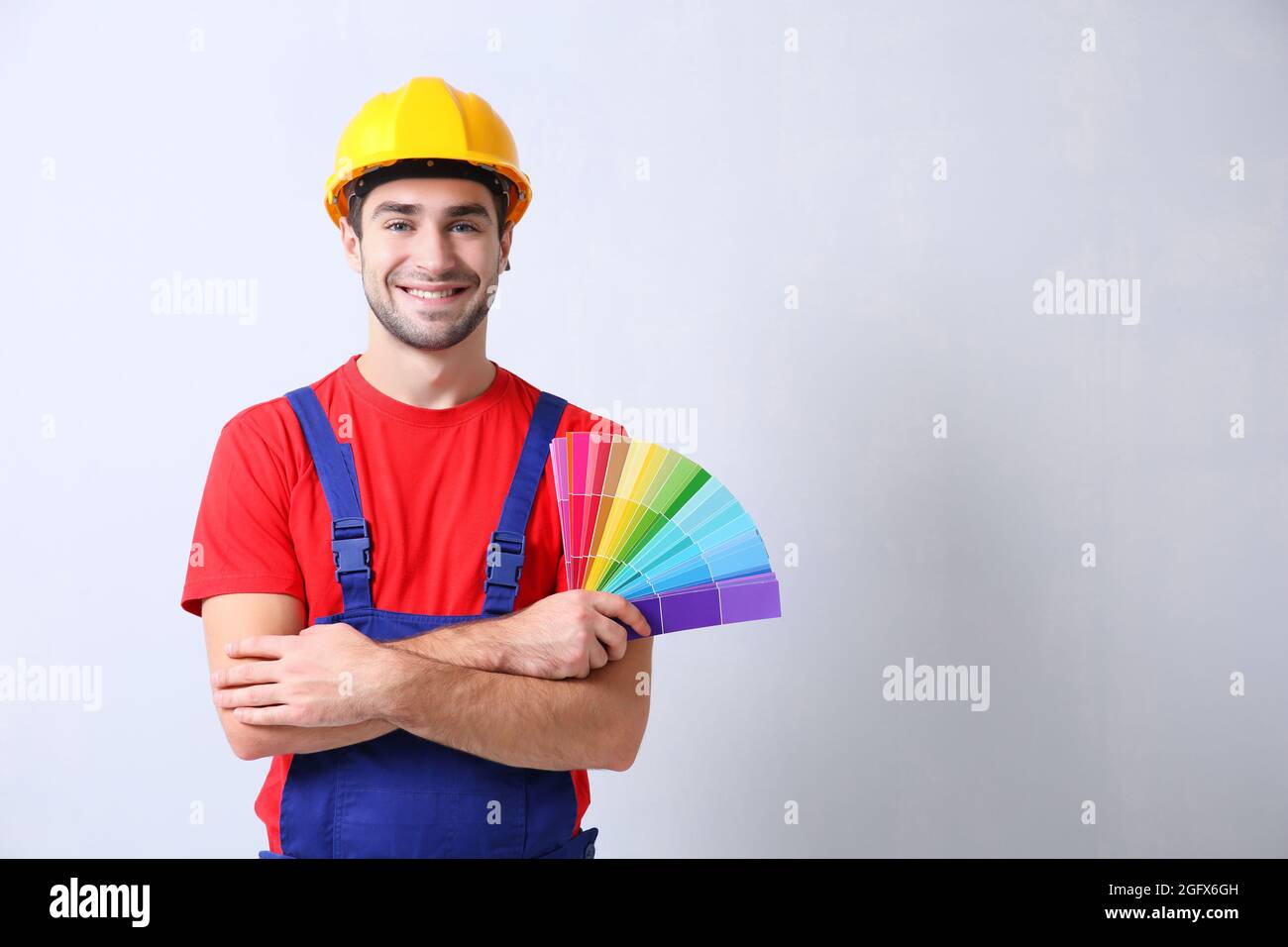 Worker holding samples for choosing color of wall Stock Photo - Alamy