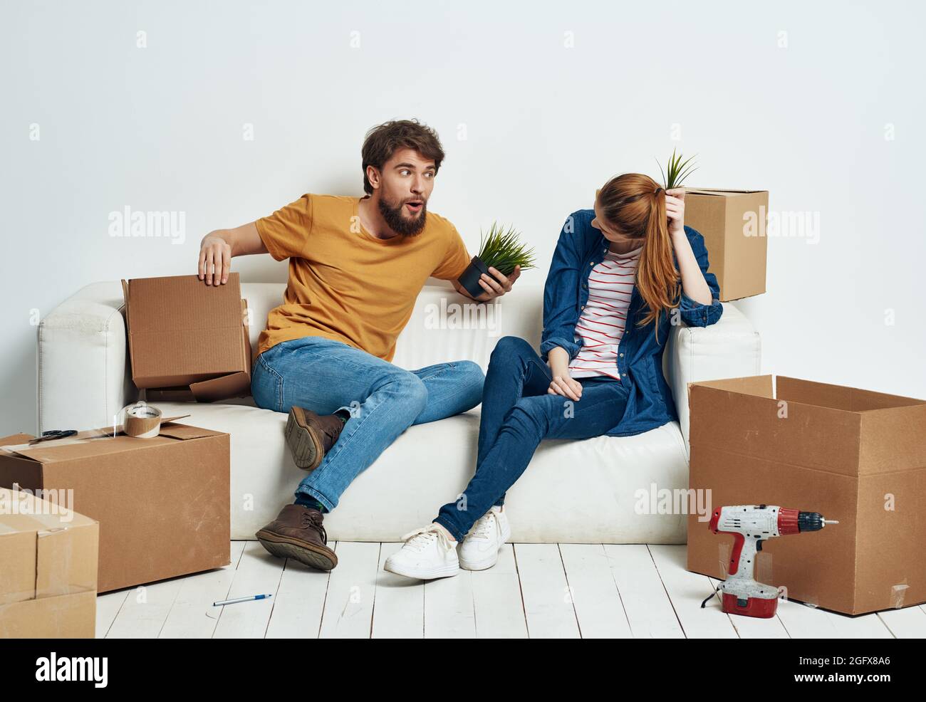 young couple unpacking boxes moving to a new apartment Stock Photo - Alamy