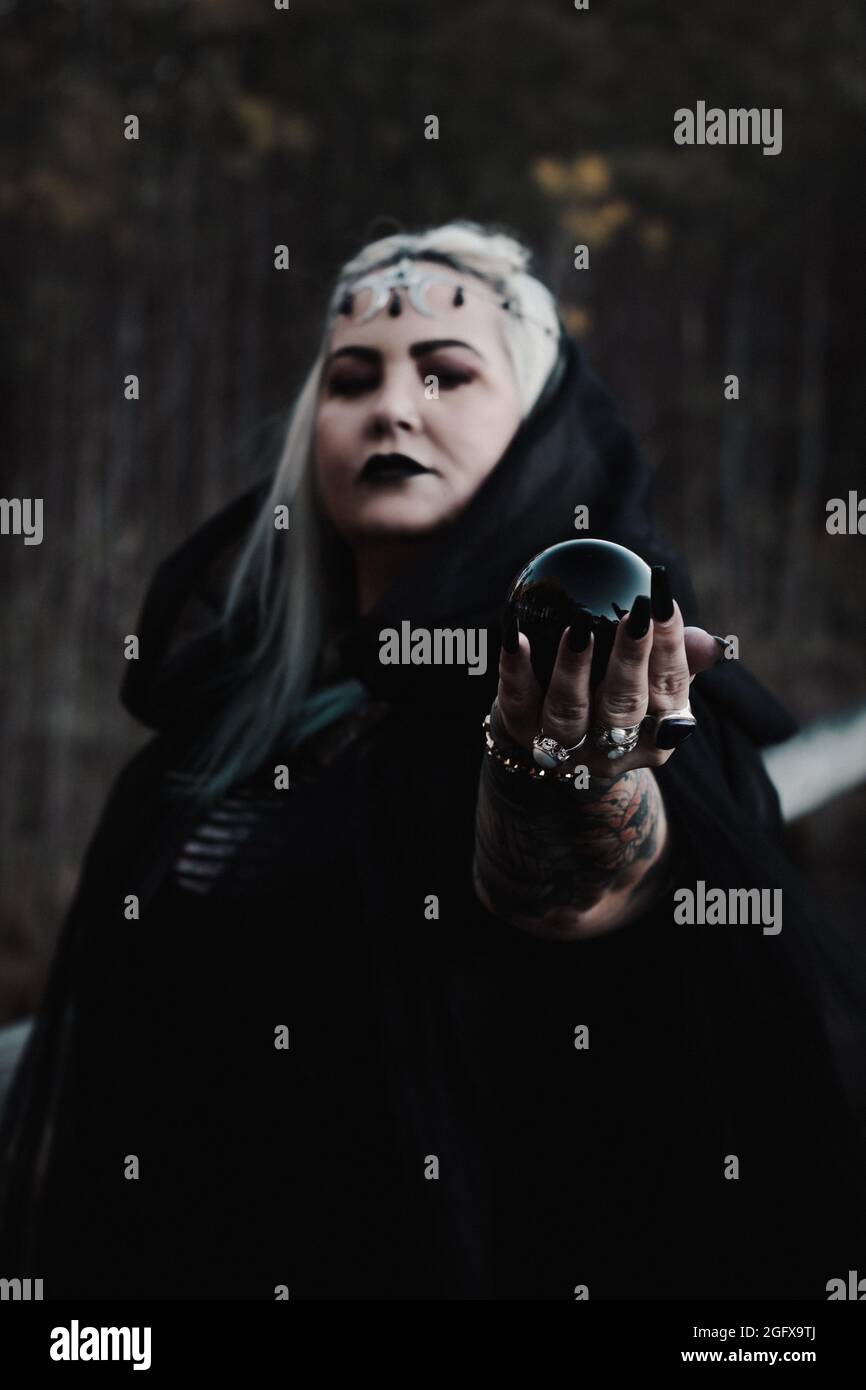 Incredible dark & moody shot of a magic crystal ball - and the witch ...