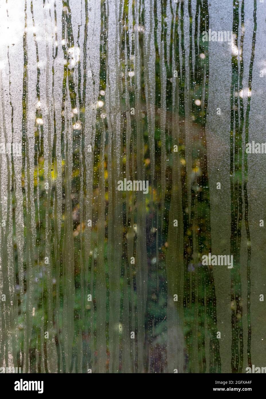 abstract photography with wet and sweaty window, raindrop texture ...