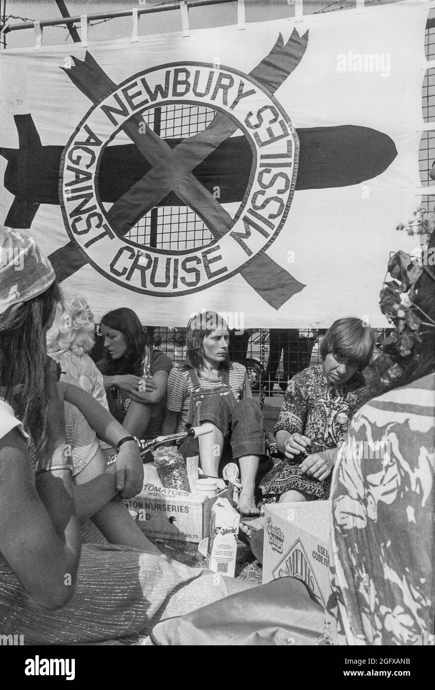 1981. Greenham Common Peace Camp. Women sitting at the perimeter fence ...