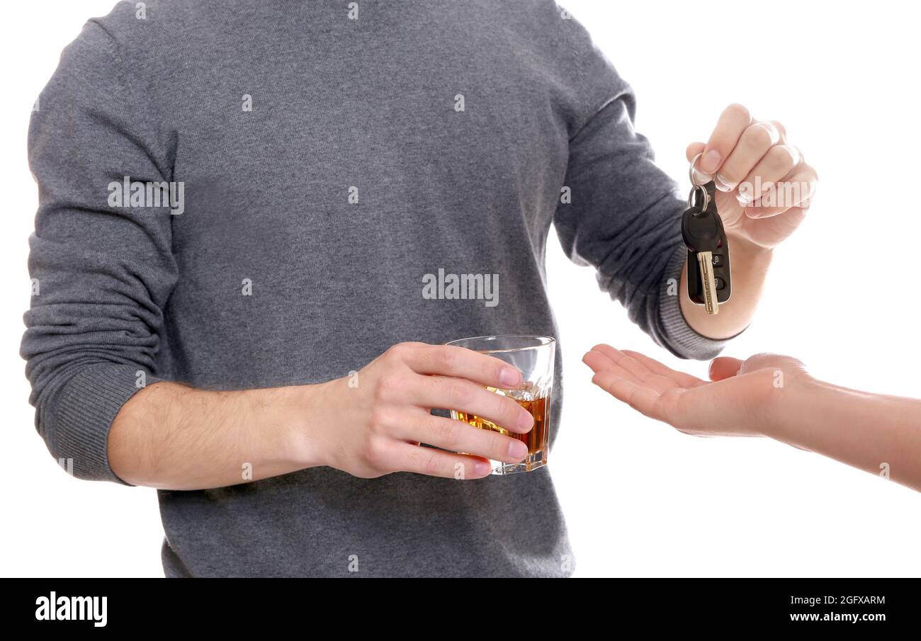 Close up view of drunk man giving car key to woman, on white background ...