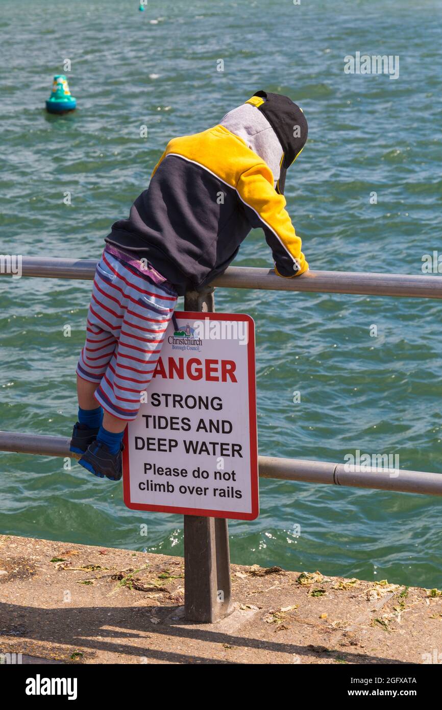 Boy climbing on railings hi-res stock photography and images - Alamy