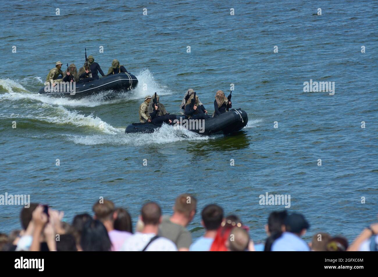 Miltary boats floating on water, armed soldiers of Special Forces ...
