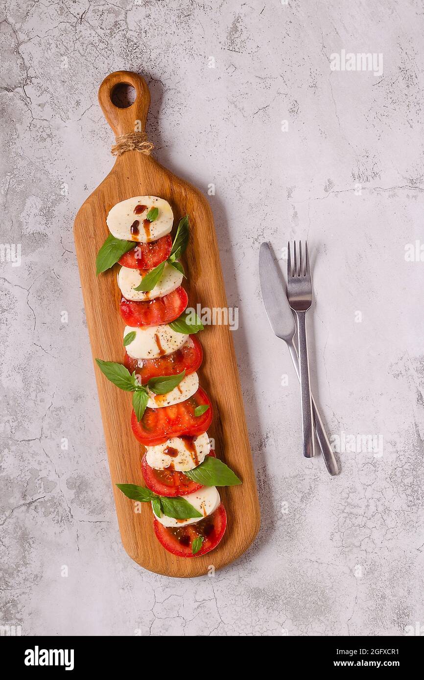 Italian caprese salad with sliced tomatoes, mozzarella, basil, olive ...