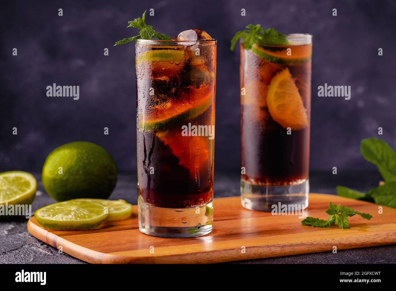 Rum and Cola cocktail Cuba Libre with lime and ice Stock Photo - Alamy