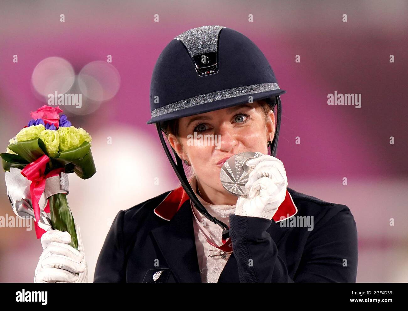 Great Britain's Natasha Baker poses with her silver medal on the podium ...