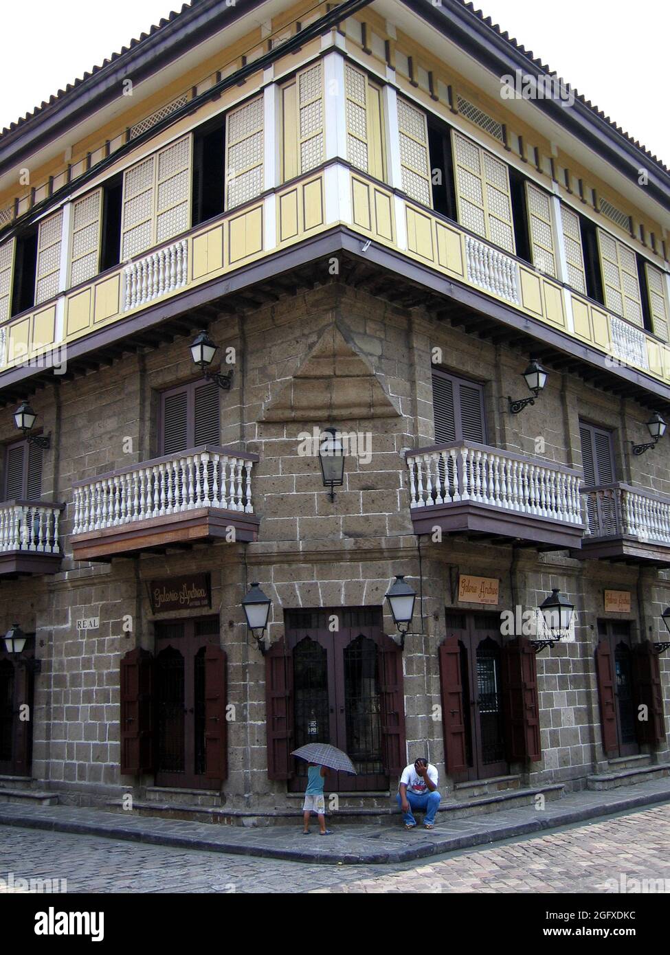 MANILA, PHILIPPINES - Apr 30, 2006: A man in an old corner Spanish ...