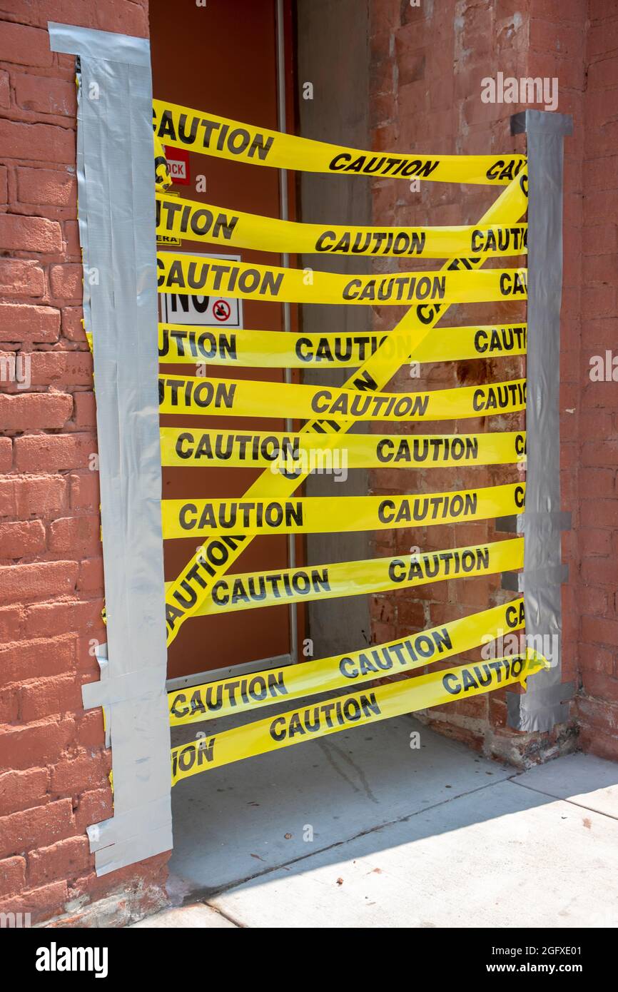 Caution tape blocking a building entrance in San Francisco, California ...