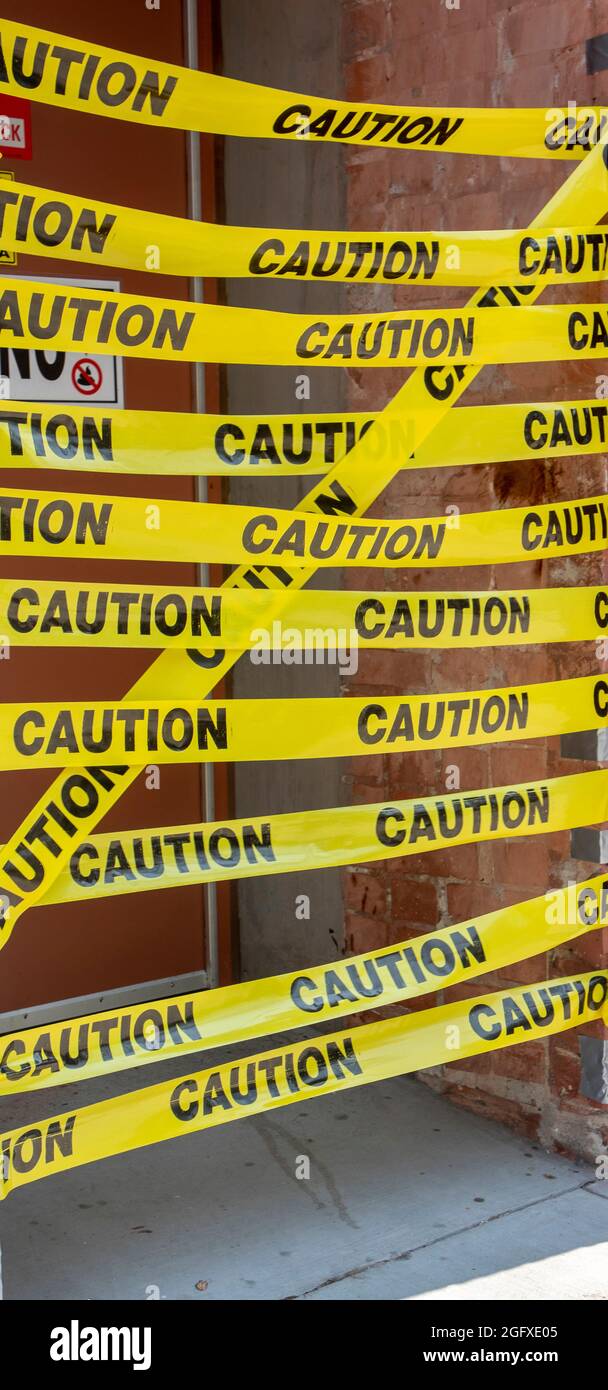 Caution tape blocking a building entrance in San Francisco, California ...
