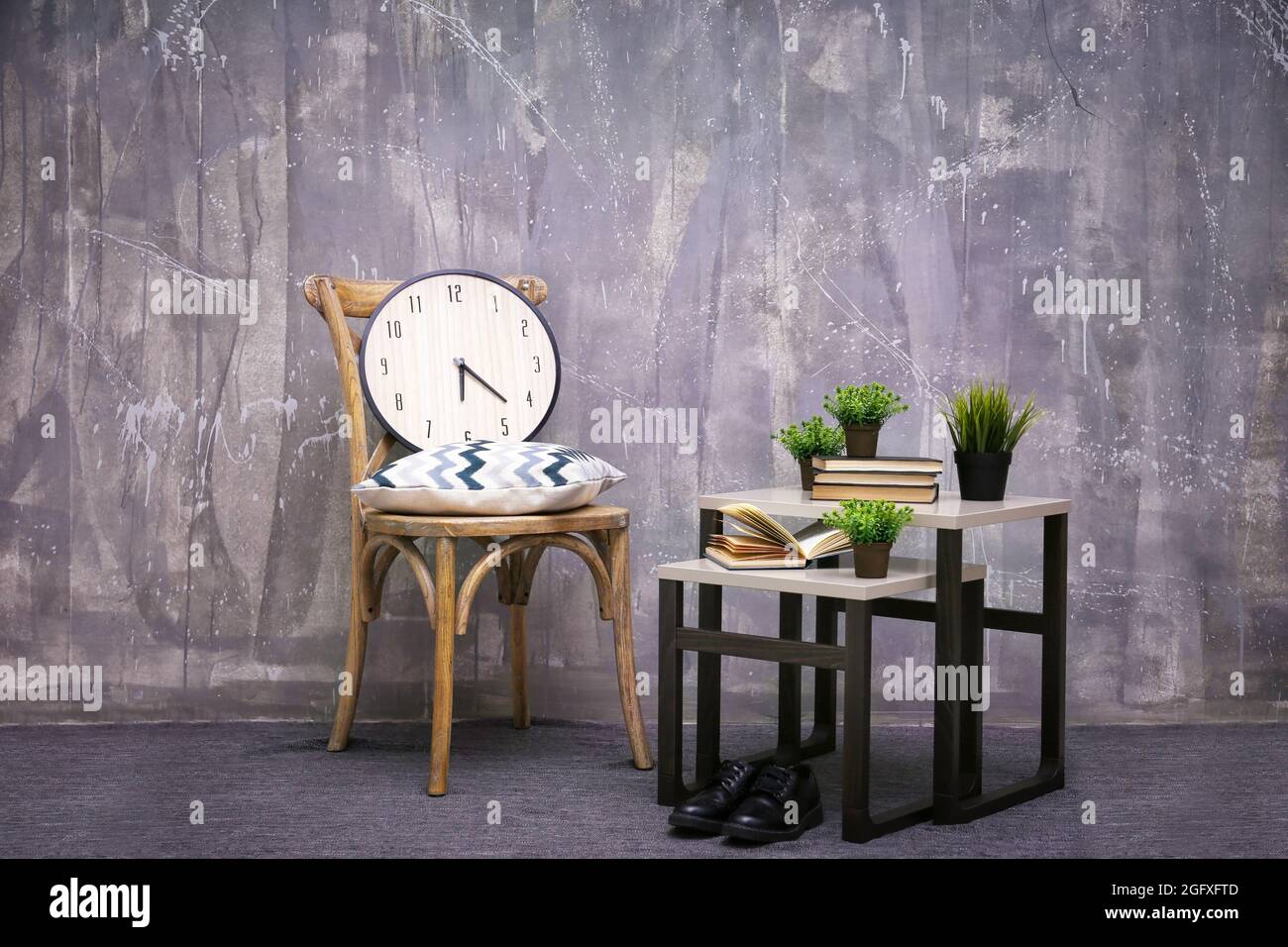 Modern interior design with wooden chair and little table on grey ...