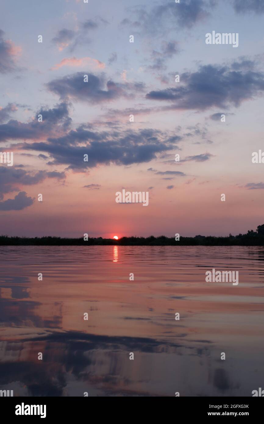 Scarlet sunset on the river, summer time Stock Photo - Alamy