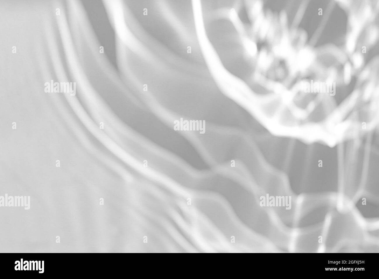 blurred shadow and light caustic effect on a white wall Stock Photo - Alamy