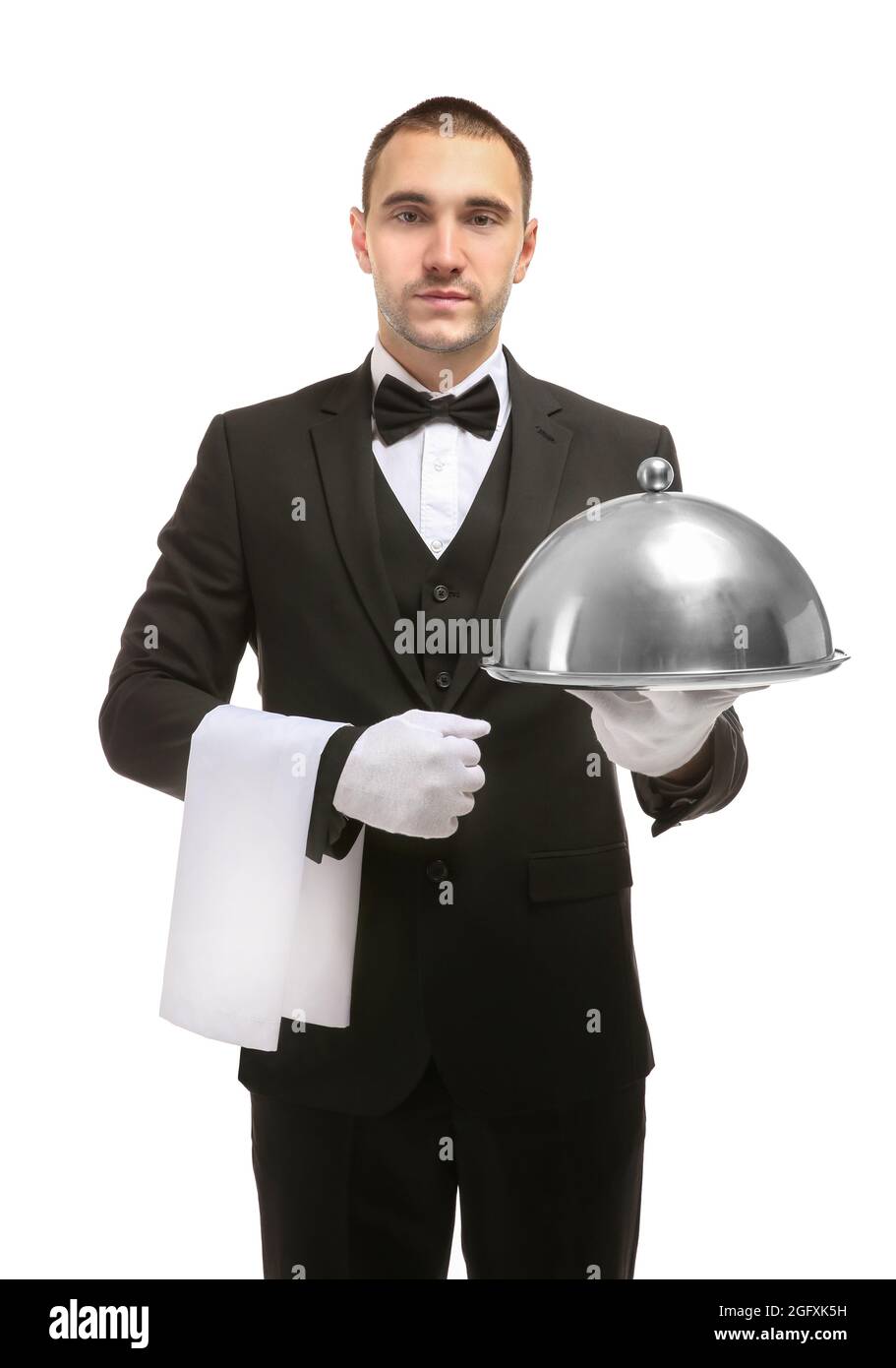 Handsome waiter holding serving tray with metal cloche and napkin on ...