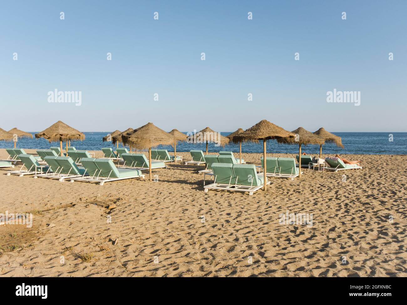 Parasols and sunbeds on the beach spain hi-res stock photography and ...