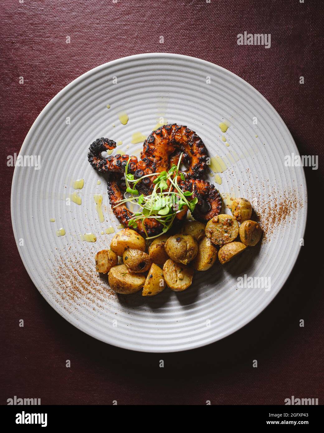 Vertical top view of a plate of deliicous roasted potatoes with fried ...