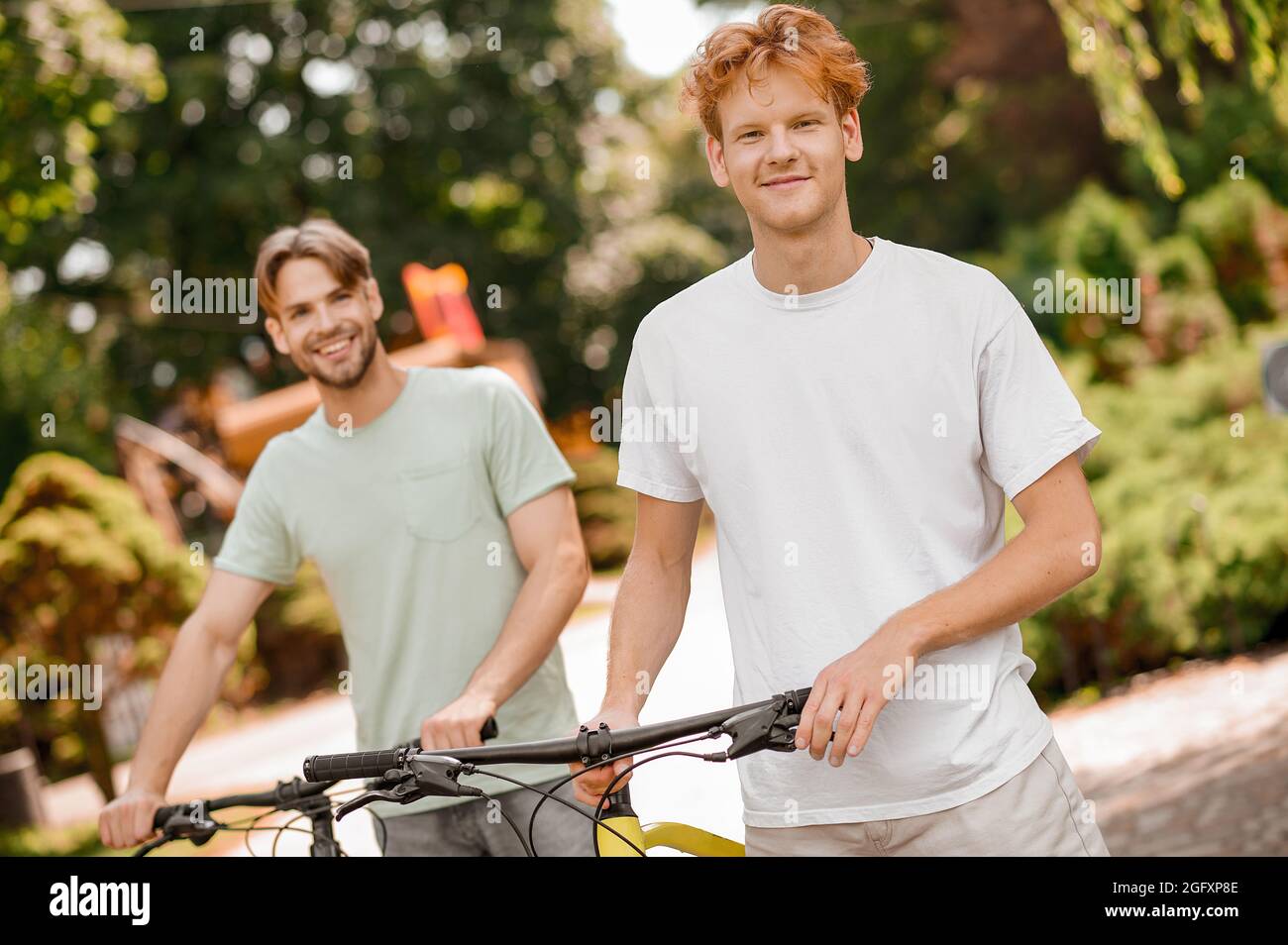 Two cute bike riders posing for the camera Stock Photo - Alamy