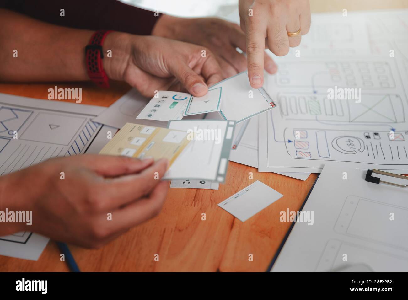 UX or UI designers designing on digital tablet and smartphone ...