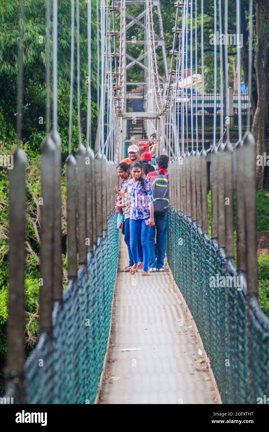 KANDY, SRI LANKA - JULY 18, 2016: People at a suspension foot bridge in ...