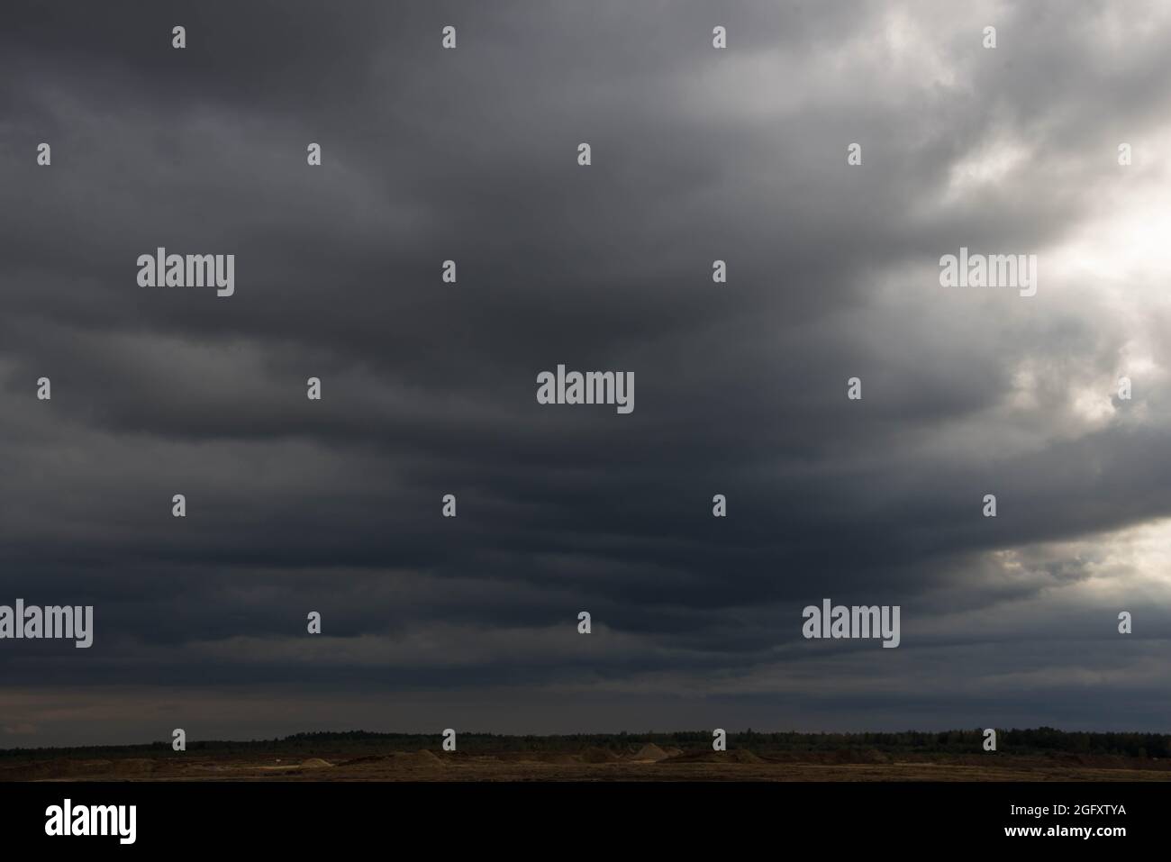 A vast plain covered with arable fields and meadows. The sky is ...