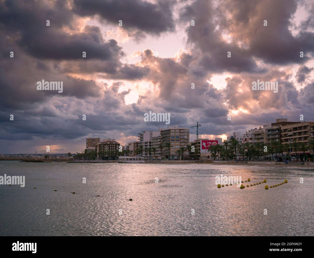 The skyline of the Mediterranean city of Torrevieja under a colourful ...