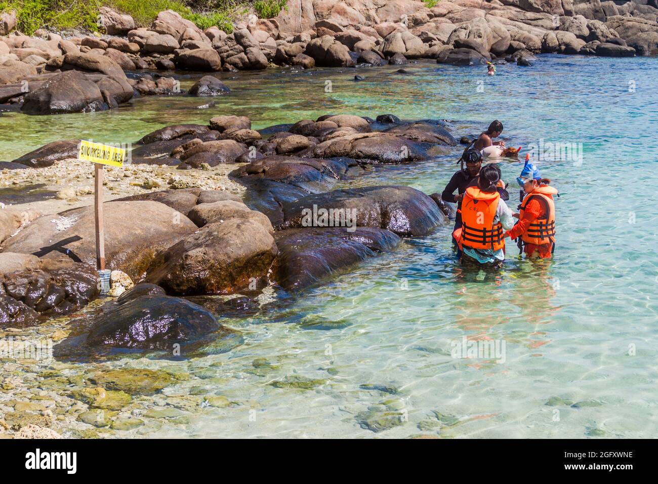 PIGEON ISLAND, SRI LANKA - JULY 25, 2016: People go snorkel on a coral ...