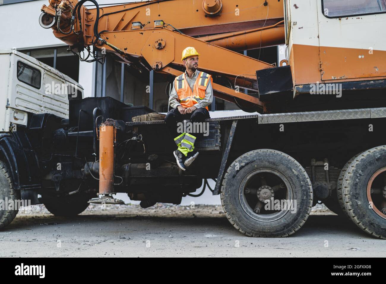 Man sitting on crane hi-res stock photography and images - Alamy