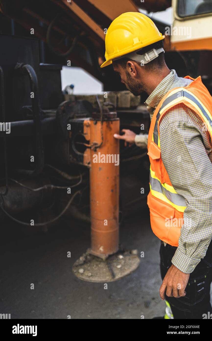 Vertical closeup of the worker checking the machinery Stock Photo - Alamy