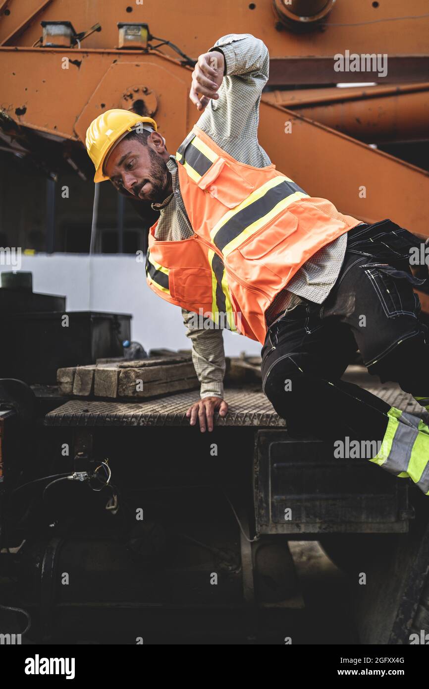 Vertical closeup of the worker jumping from the vehicle Stock Photo - Alamy