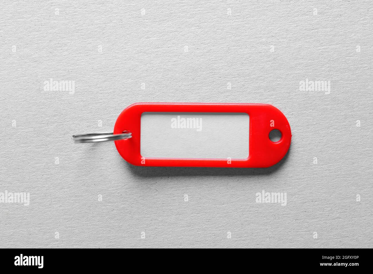 Red key tag on light background Stock Photo - Alamy