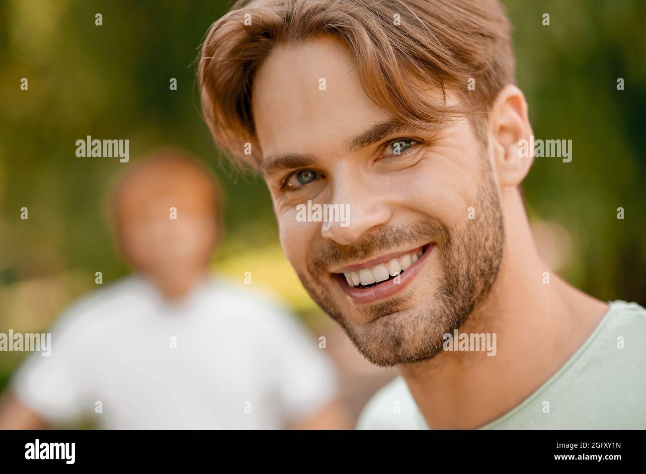 Smiling contented gorgeous guy posing for the camera Stock Photo - Alamy