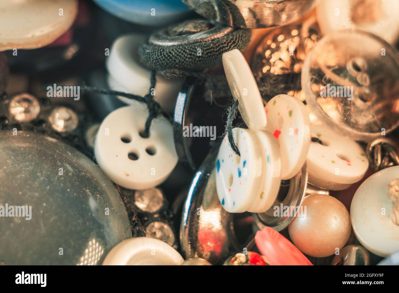 Selective focus shot of a stack of mixed cloth buttons of different ...