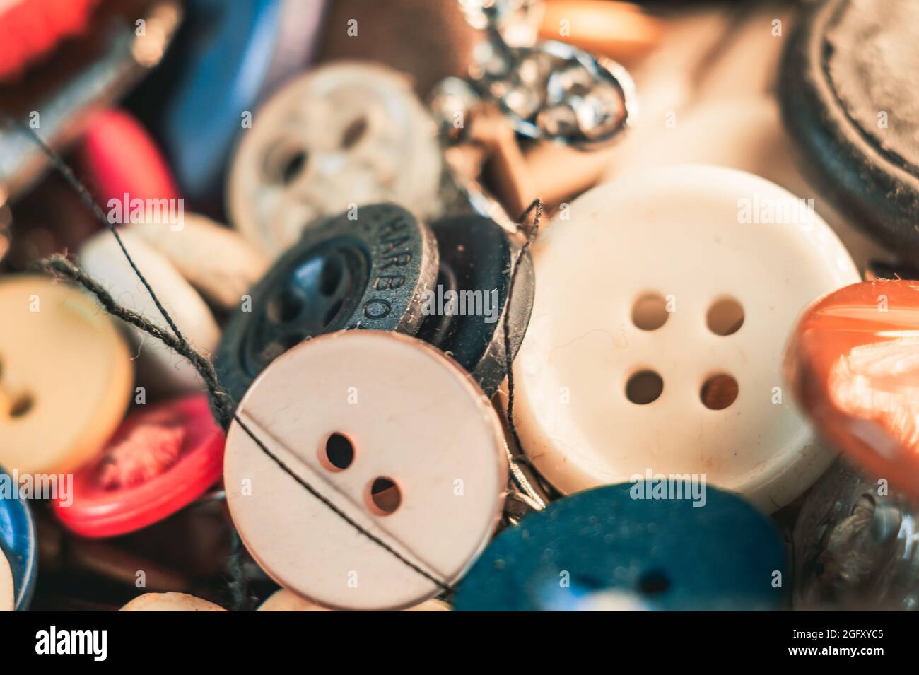 Selective focus shot of a stack of mixed cloth buttons of different ...