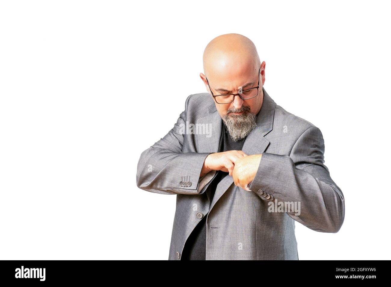 Caucasian male in an elegant gray suit picking up something from the ...