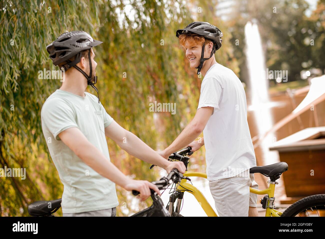 Two young men standing talking outside hi-res stock photography and ...