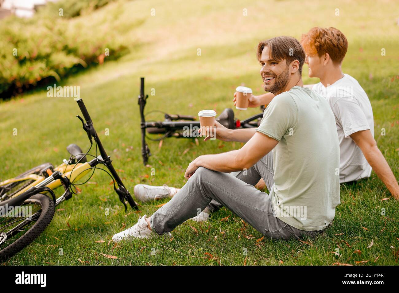 Two friends having a coffee break after their cycling training Stock ...