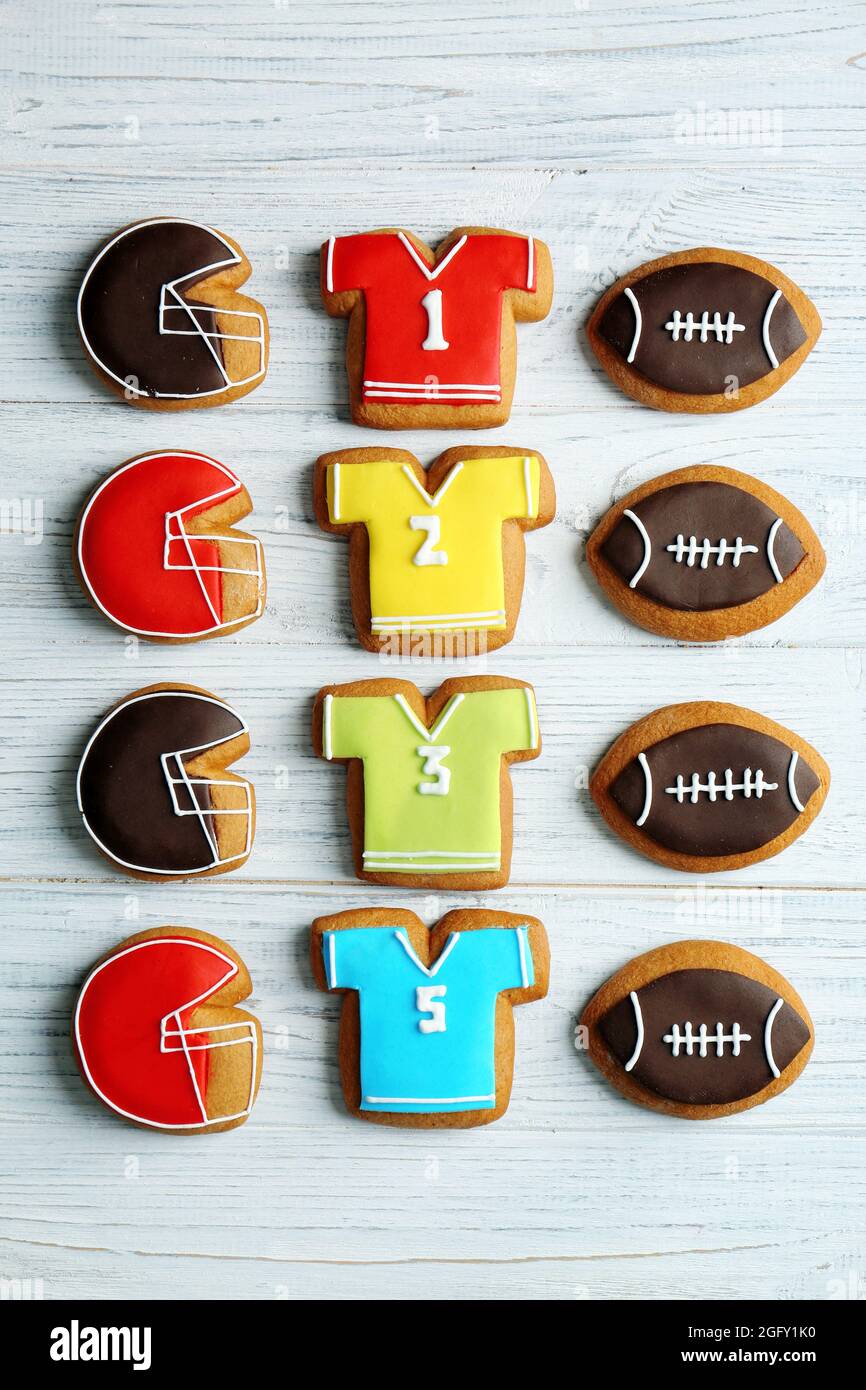 Delicious gingerbread cookies decorated with football signs on white ...
